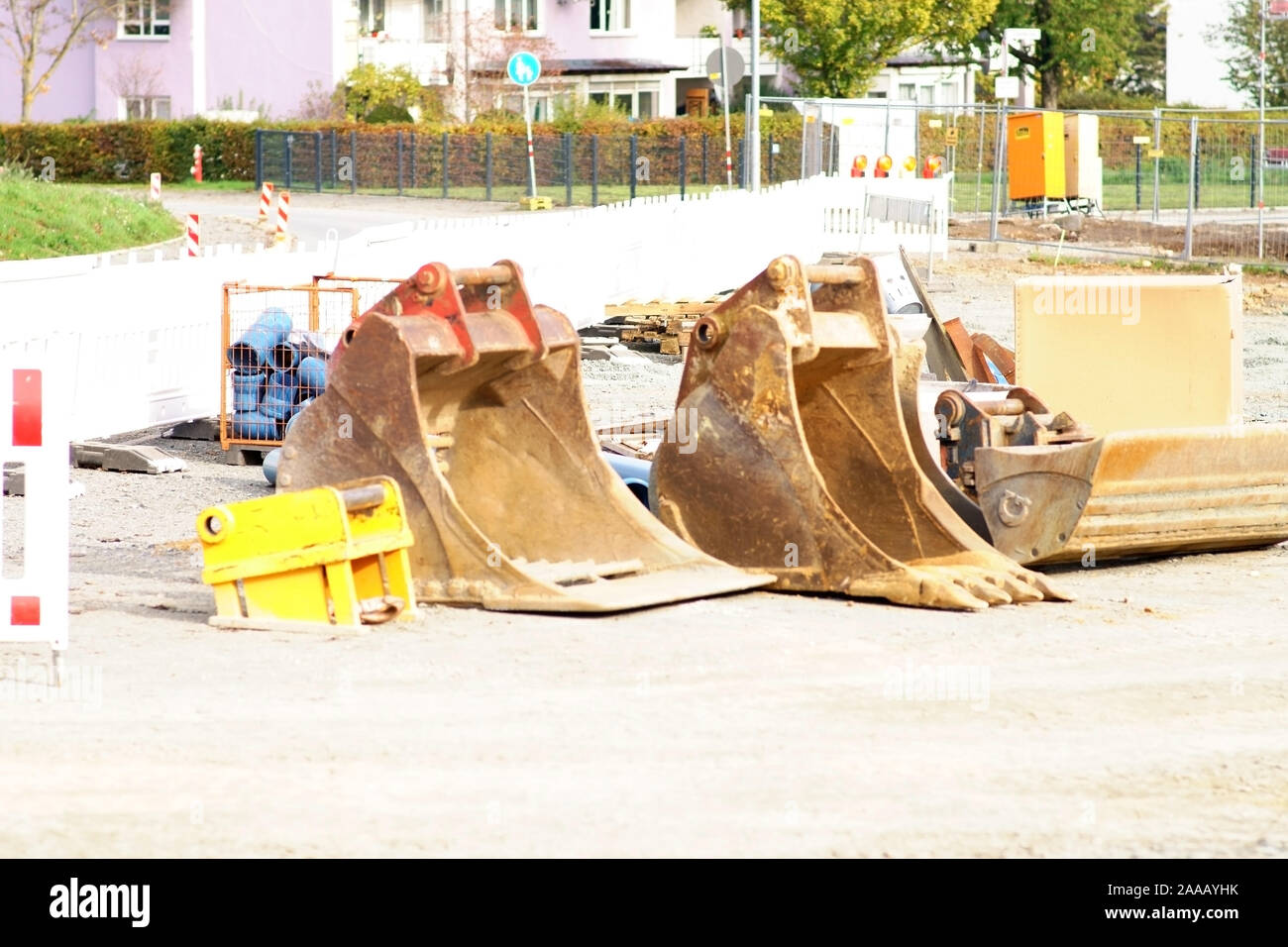 The closeup of an excavator shovel laying next to tools and materials ...