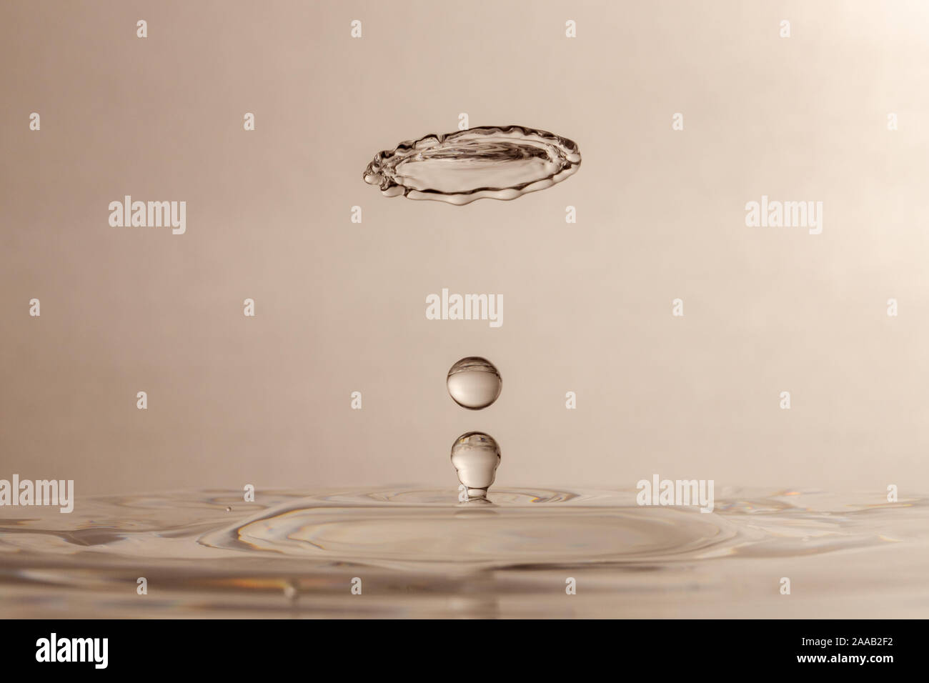 Water drops collision in sephia Stock Photo - Alamy