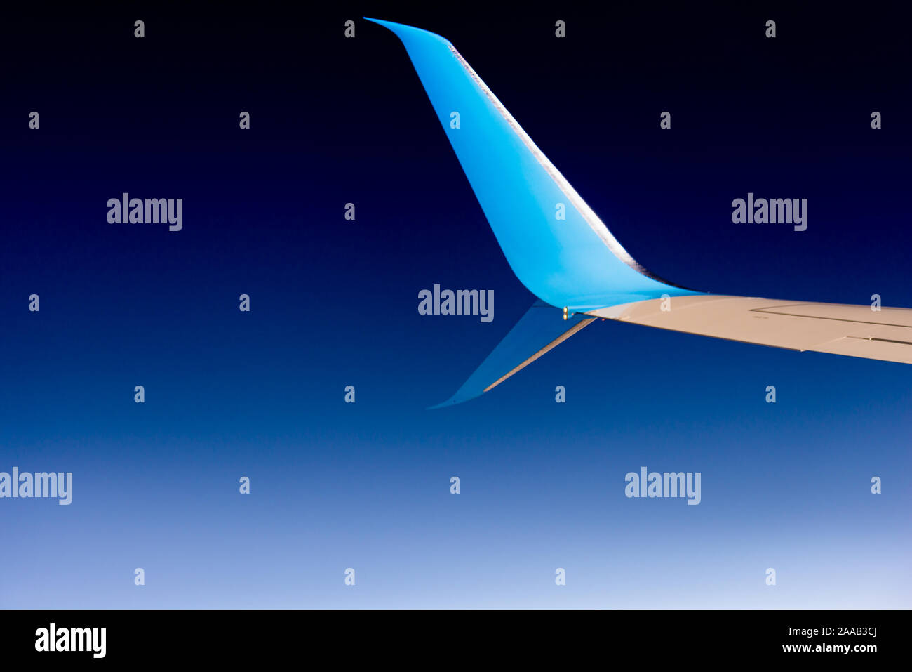 Airplane wing. Blue wing tip of the aircraft against the dark sky Stock ...