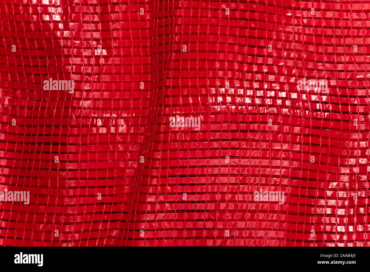 Red woven plastic net for packaging fruits, vegetables, or products ...