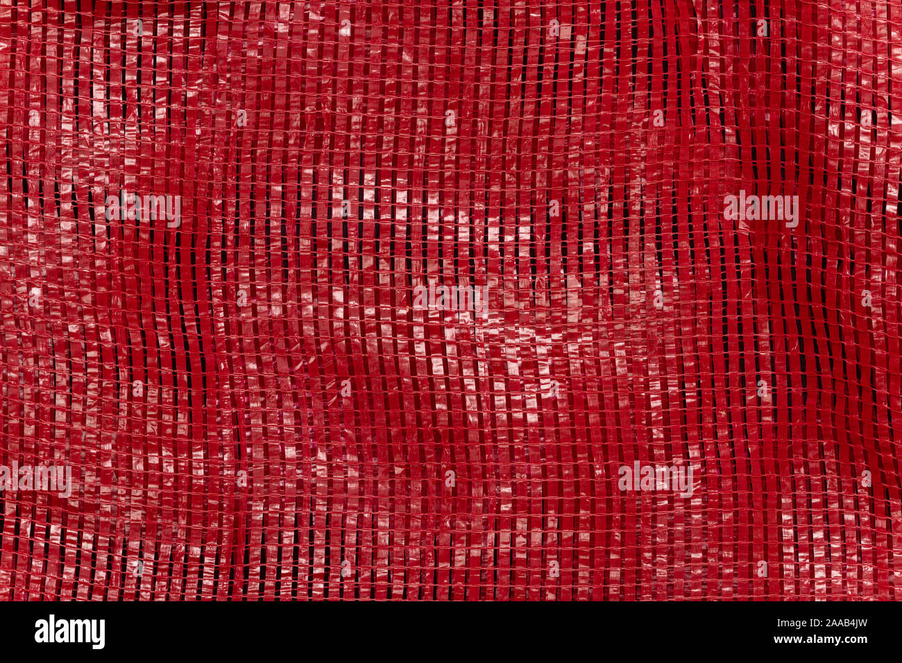 Red woven plastic net for packaging fruits, vegetables, or products ...