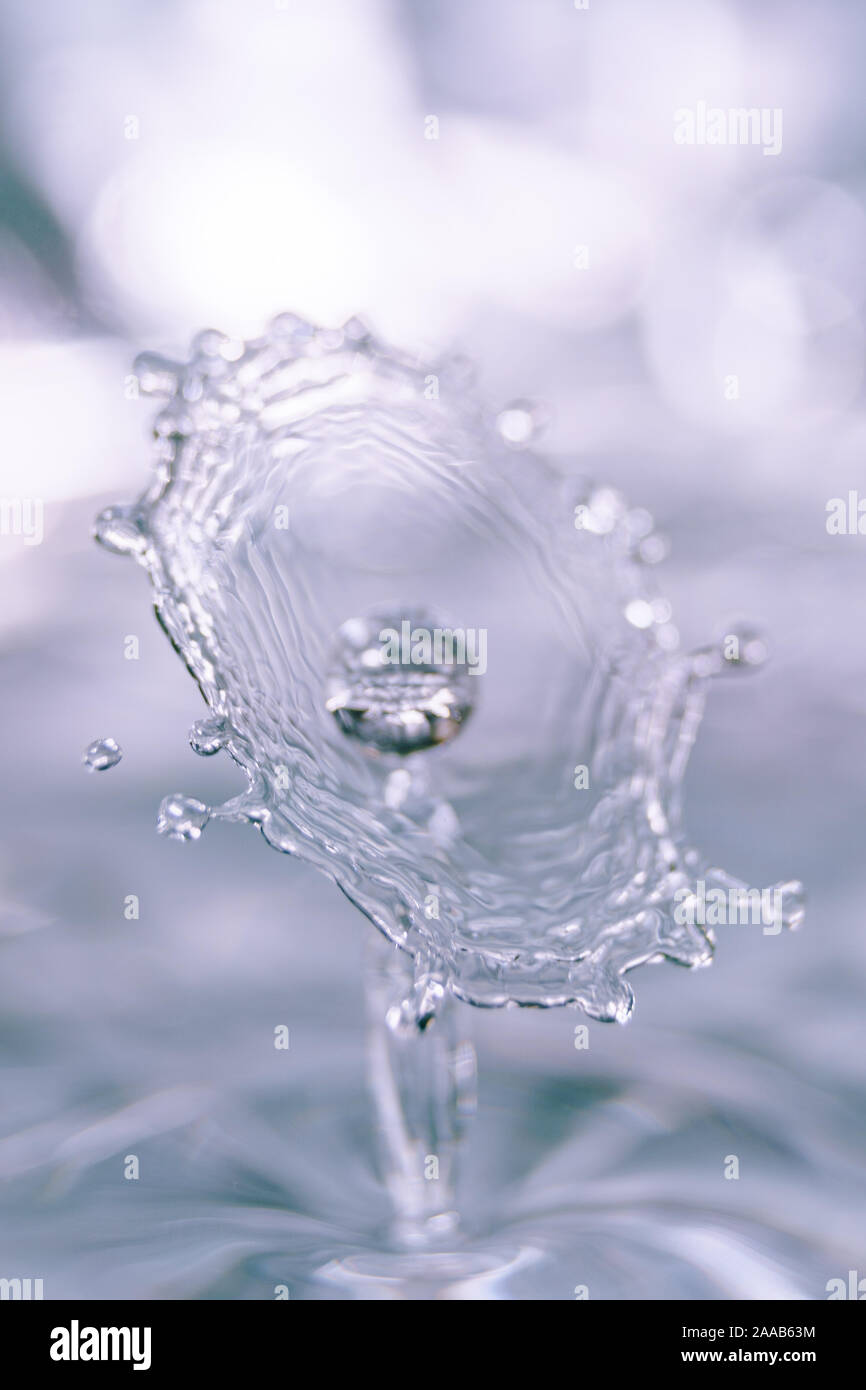 Water drop collision form metallic background Stock Photo - Alamy