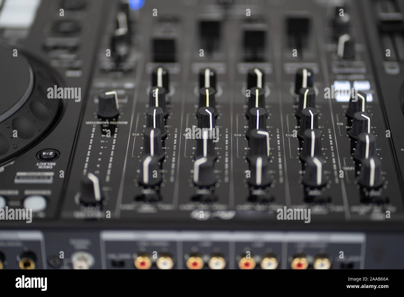 Wide angle photo of black sound mixer controller with knobs and sliders ...