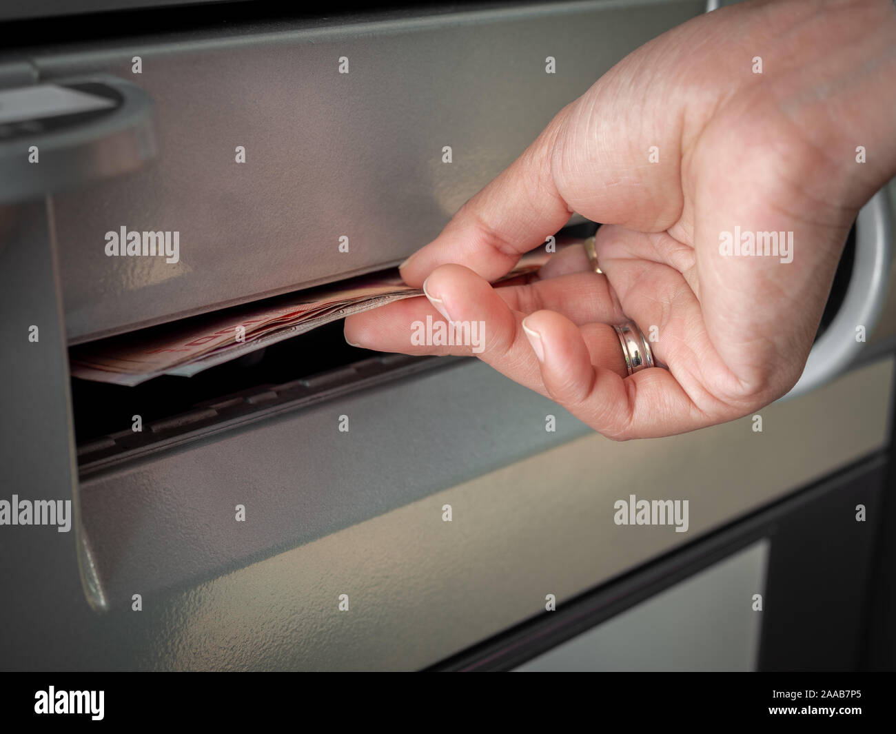 Close-up hand withdraw money, the banknotes thai baht from ATM machine ...