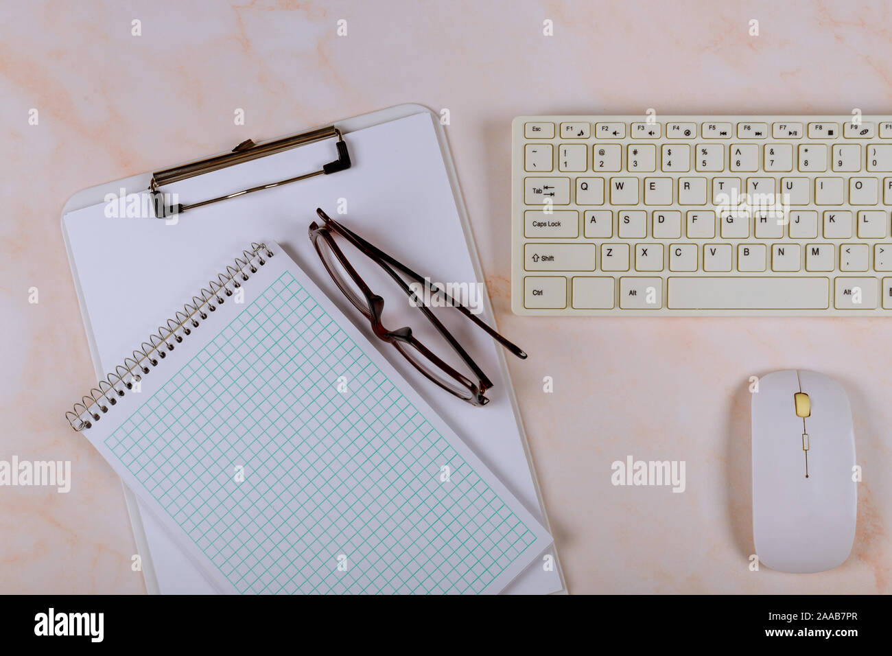 Office table with blank notebook and computer keyboard on a wooden ...
