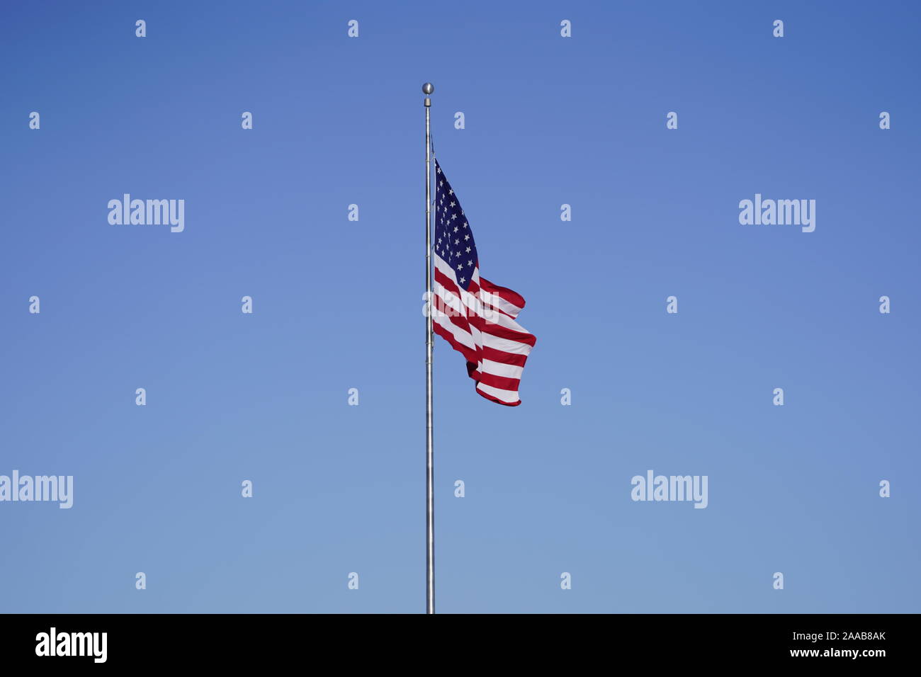 The American flag stands in the cold windy weather Stock Photo - Alamy