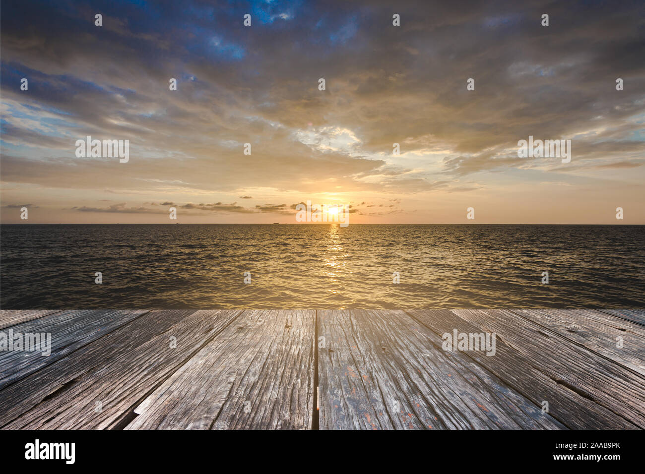 old wooden table and dark sky with drop of sunset between sky and ocean ...