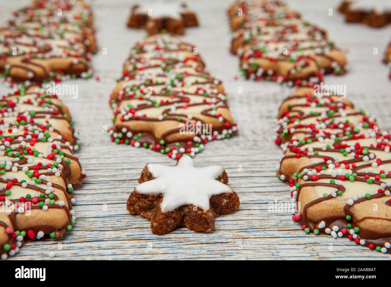 Christmas tree biscuits and almond stars dessert on white wood in ...