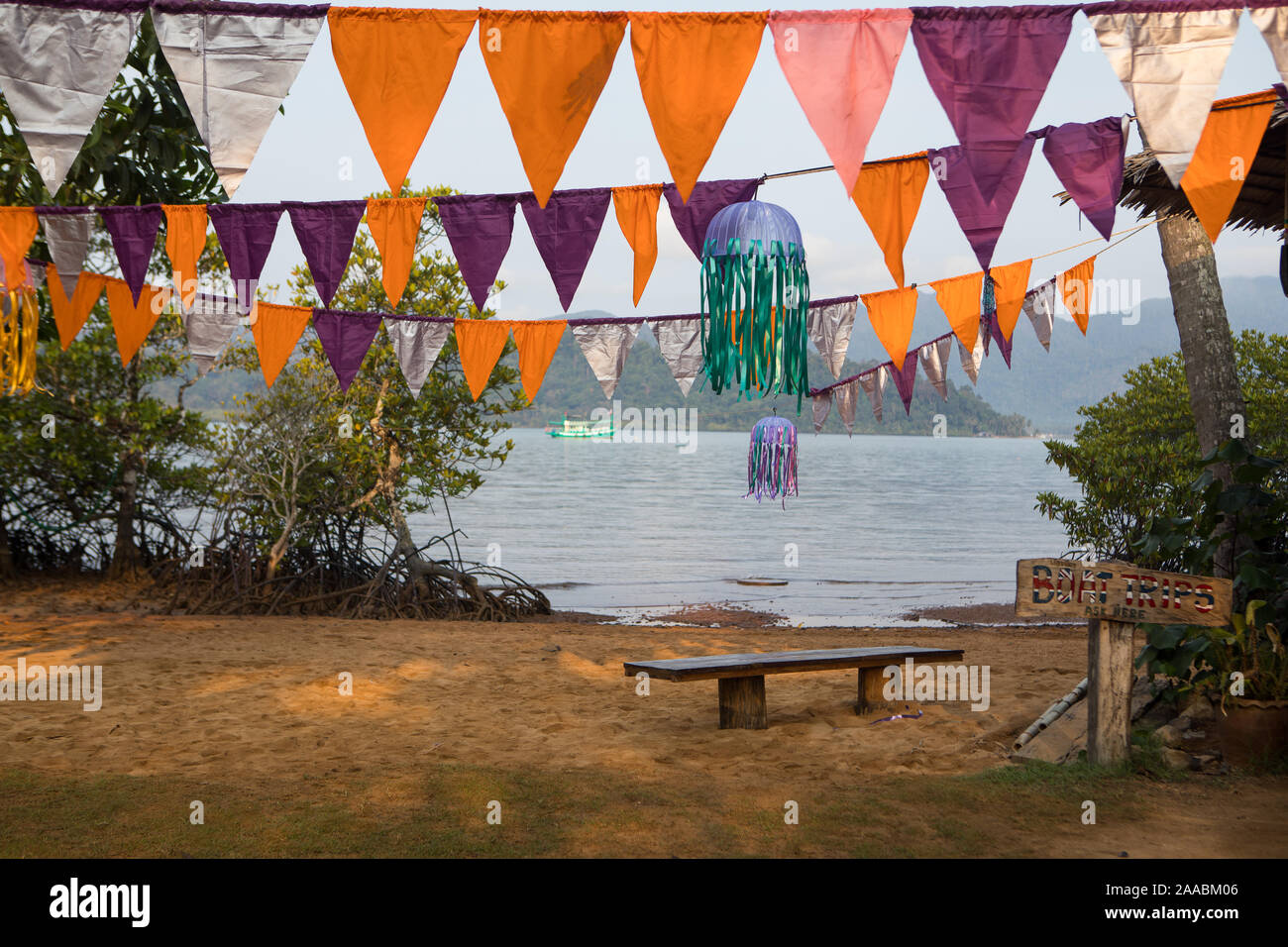 Festive multicolored flags decoration on the beach in the tropics on ...