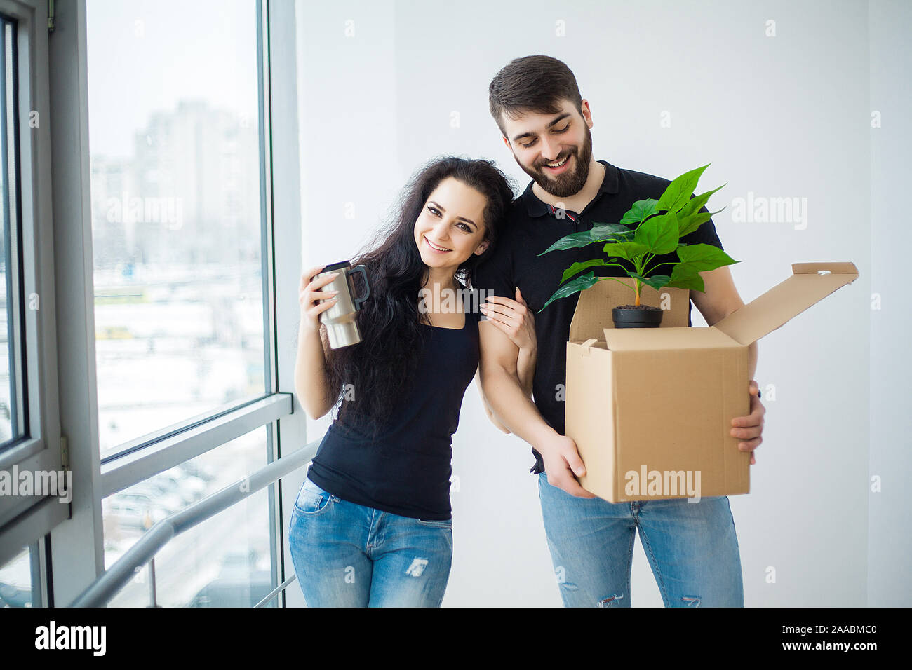 Smiling couple unpack boxes in new home Stock Photo - Alamy