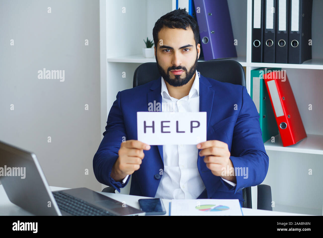 Businessman in suit and tie sitting at office desk working on computer ...