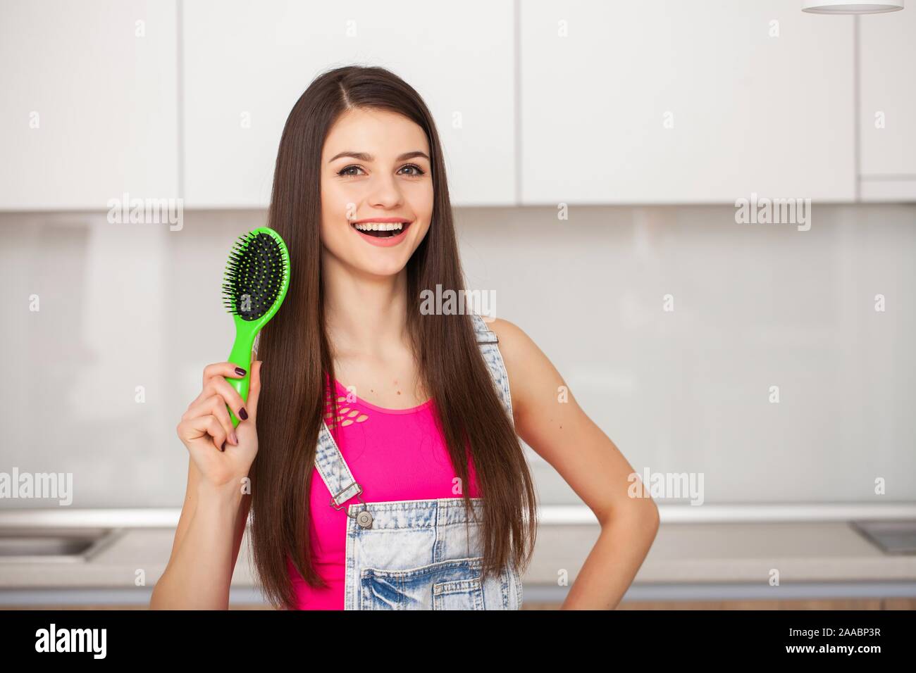 Girl holds a hairbrush without hair and smiling Stock Photo - Alamy