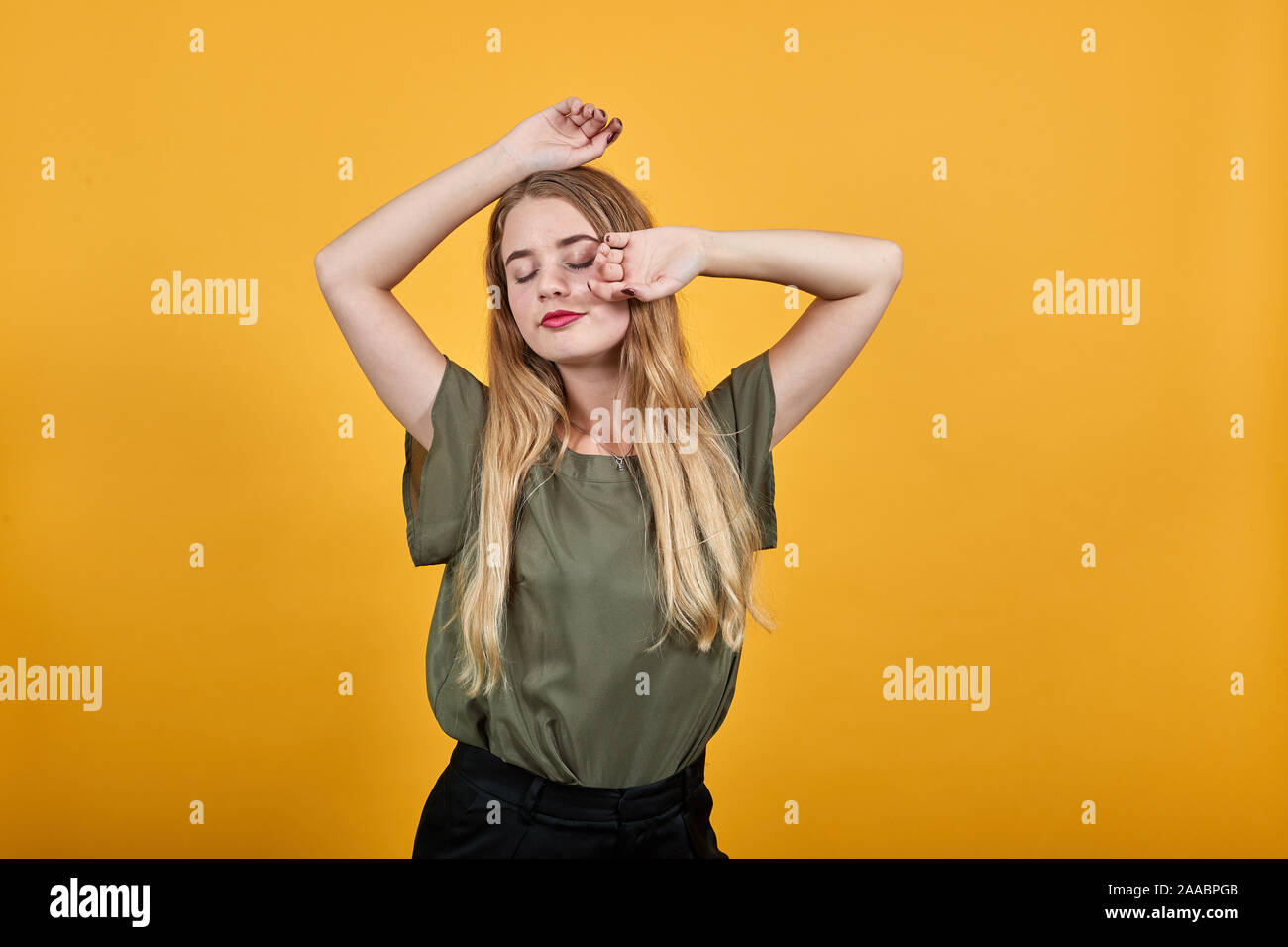 Pretty young girl true beauty, position, keeping hands up closed eyes ...