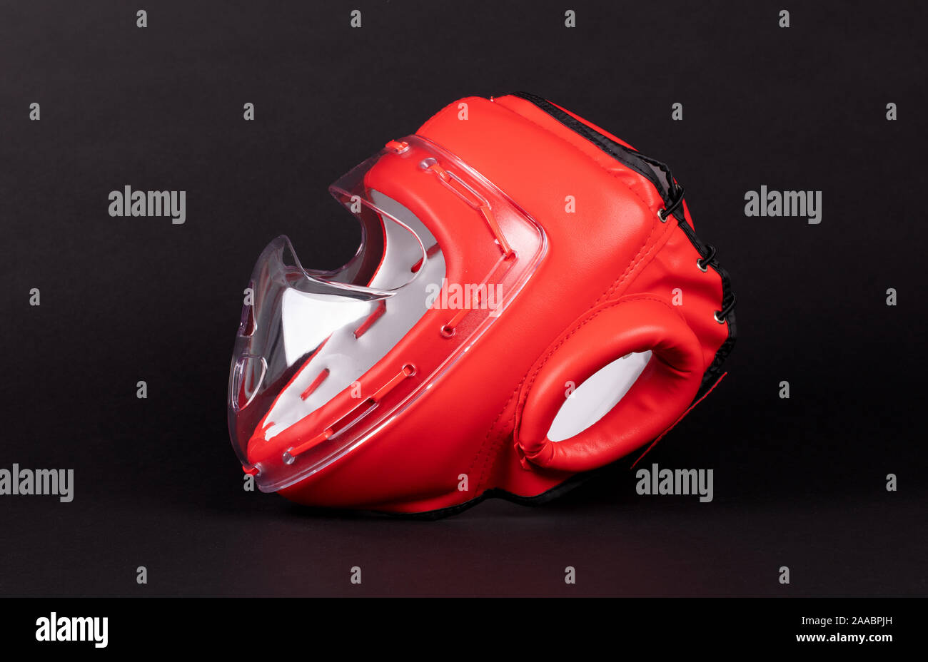 Red boxing helmet, modern headgear isolated on black Stock Photo - Alamy