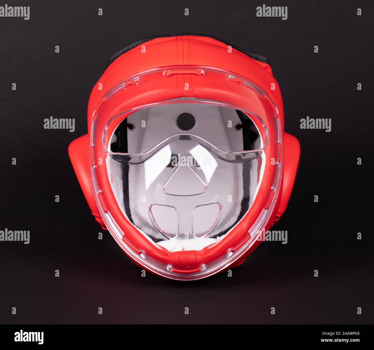 Red boxing helmet, modern headgear isolated on black Stock Photo - Alamy