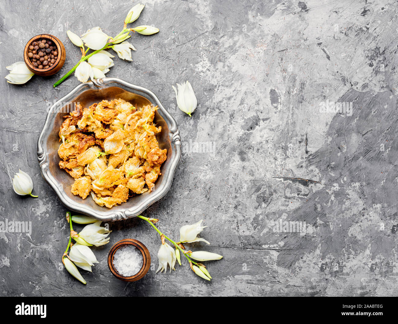 Fried yucca flowers on plate.An unusual dish of edible flowers.Space ...
