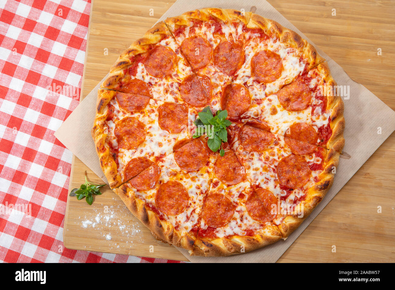 Pepperoni pizza close-up with various ingredients decorated with Basil ...