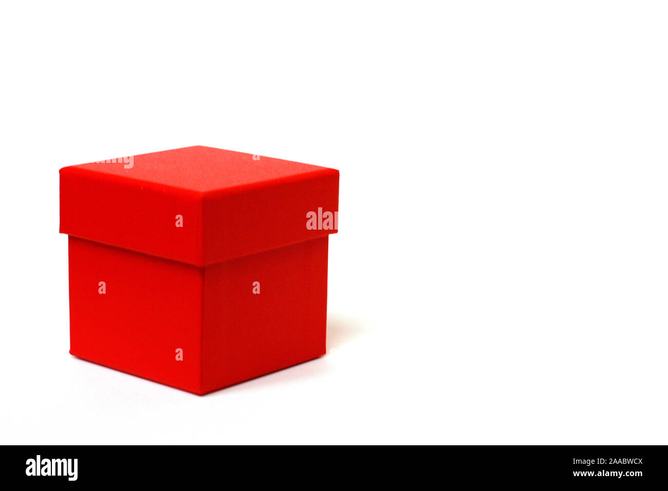 Red gift box with a lid on a white background. There is a place for ...