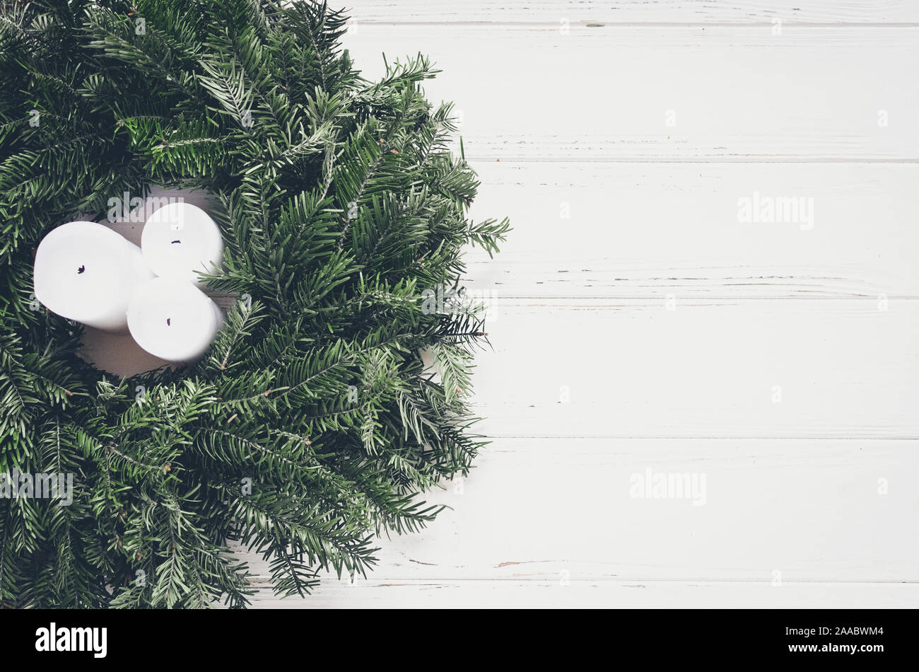 Christmas still life with lighted candles and fir tree branches wreath ...