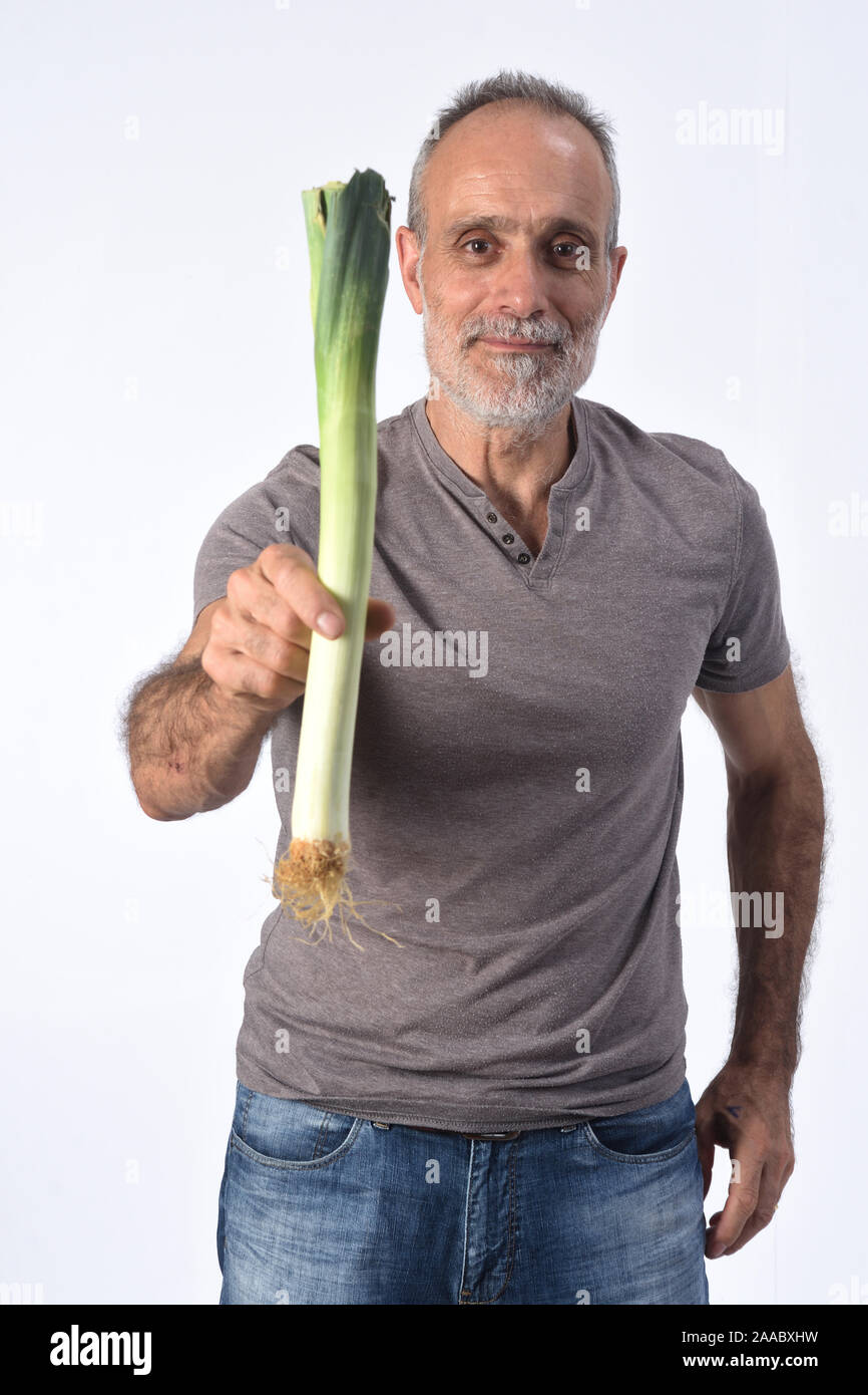 portrait of a man with leek on white background Stock Photo - Alamy