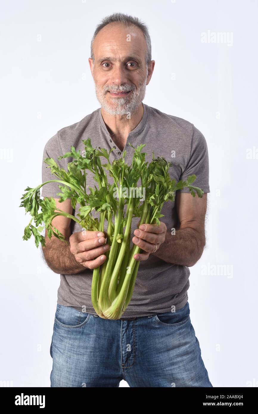 portrait of a man with celery on white background Stock Photo - Alamy