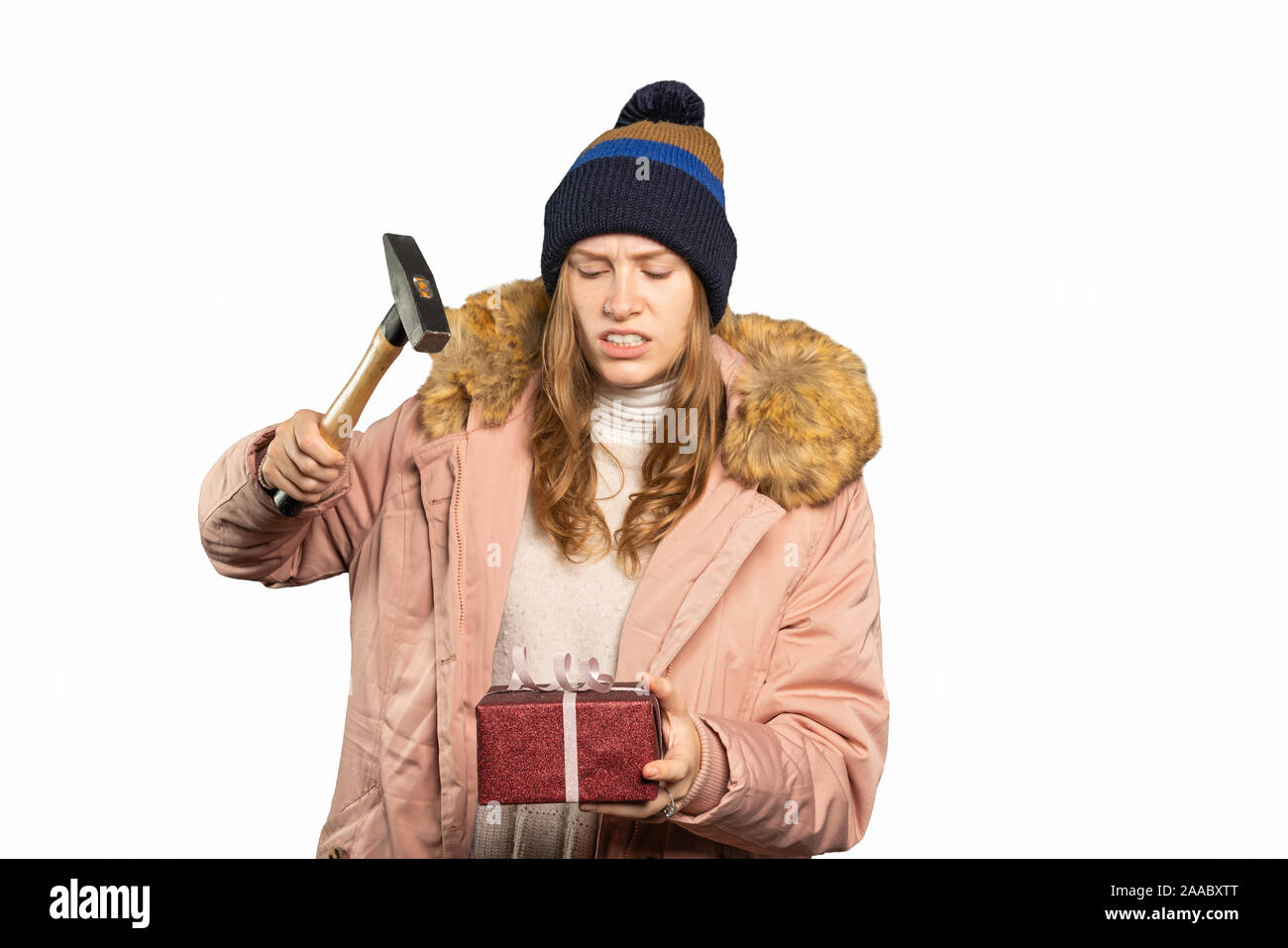 An angry young woman wants to smash her gift with a hammer Stock Photo ...