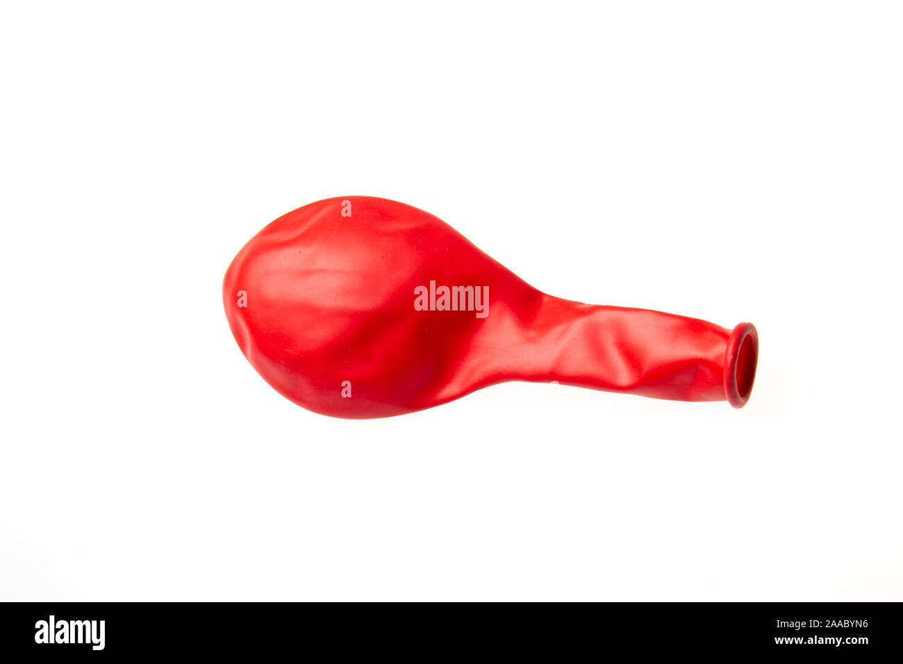 Red deflated balloon isolated on a white background Stock Photo - Alamy