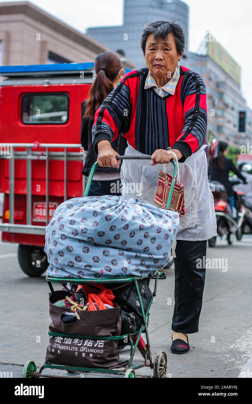 Old lady pushing trolley hi-res stock photography and images - Alamy
