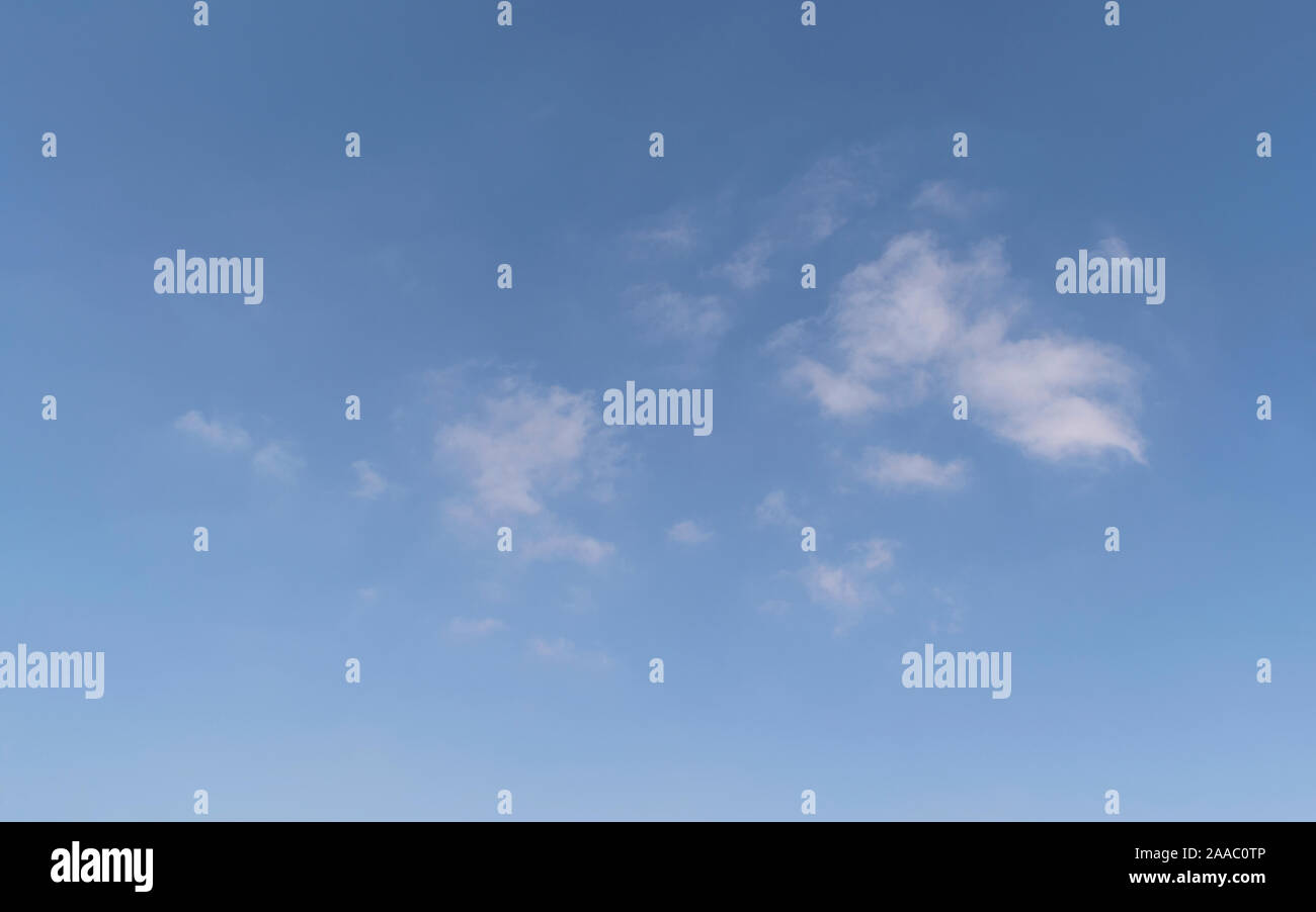 abstract cloudscape of small wispy puffy clouds in a clear blue sky ...