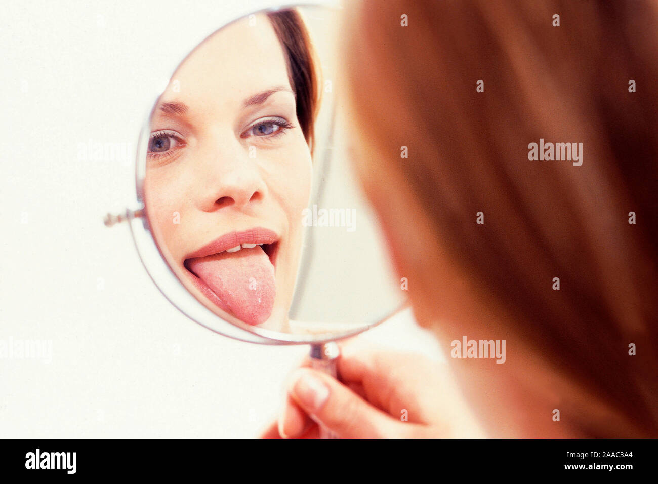 Woman pulling hair mirror hi-res stock photography and images - Alamy