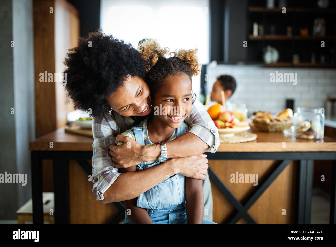 Happy mother and children in the kitchen. Healthy food, family, cooking ...