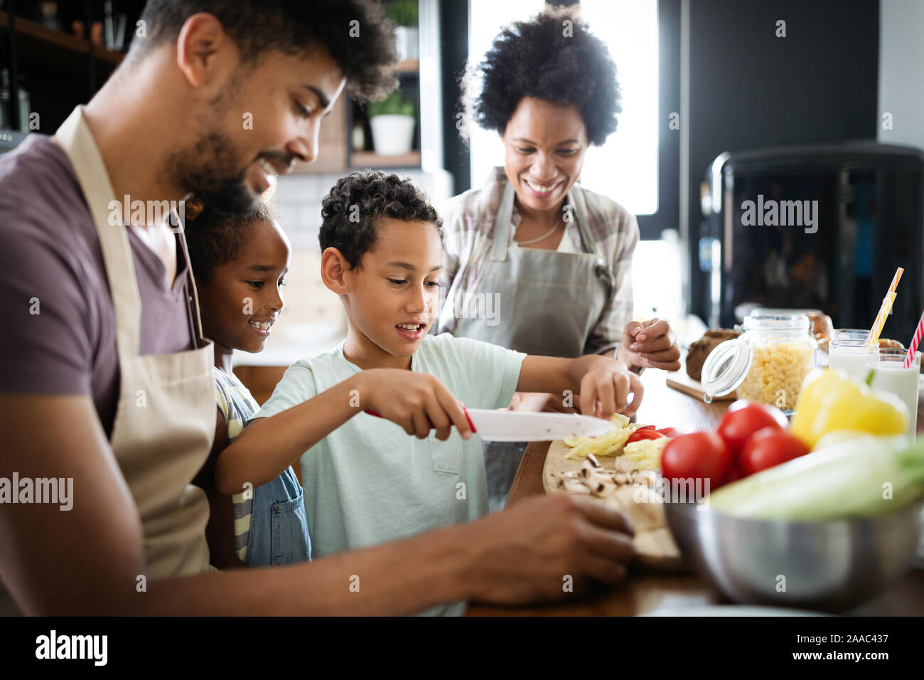 Happy family in the kitchen having fun and cooking together. Healthy ...