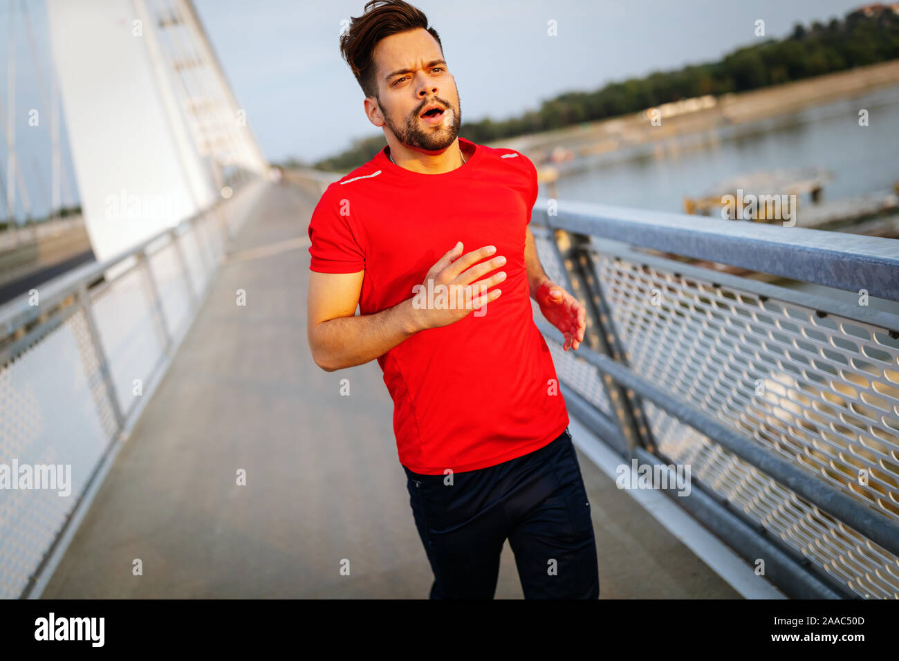Fit young man running outdoor. Healthy lifestyle concept Stock Photo ...
