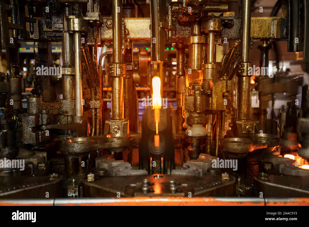 Glassworks. Glass industry. Burning blanks of glass bottles in an ...