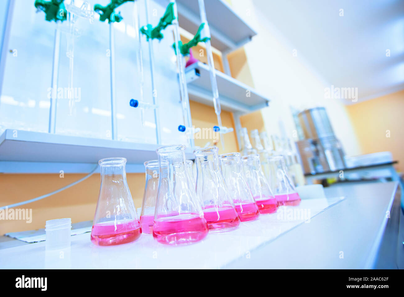 Chemical laboratory with test tubes.Pink liquid in flasks on a research ...