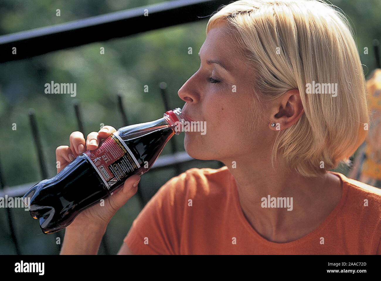 Woman and coke bottle hi-res stock photography and images - Alamy