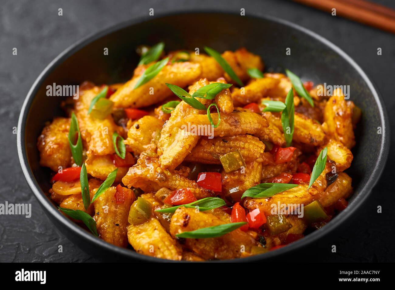 Baby Corn Manchurian dry looks like Schezwan Baby Corn in black bowl at ...