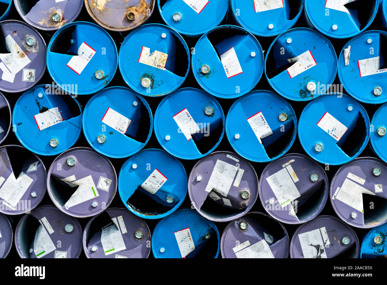 Old chemical barrels. Blue and purple oil drum. Steel oil tank. Toxic ...