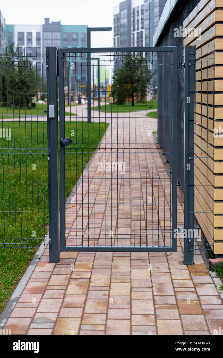 safety in modern residential buildings. fenced yard, closed gate with ...