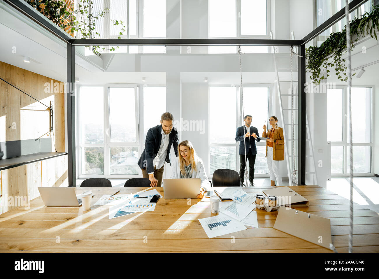 Office employees talking and having some office work at the large ...