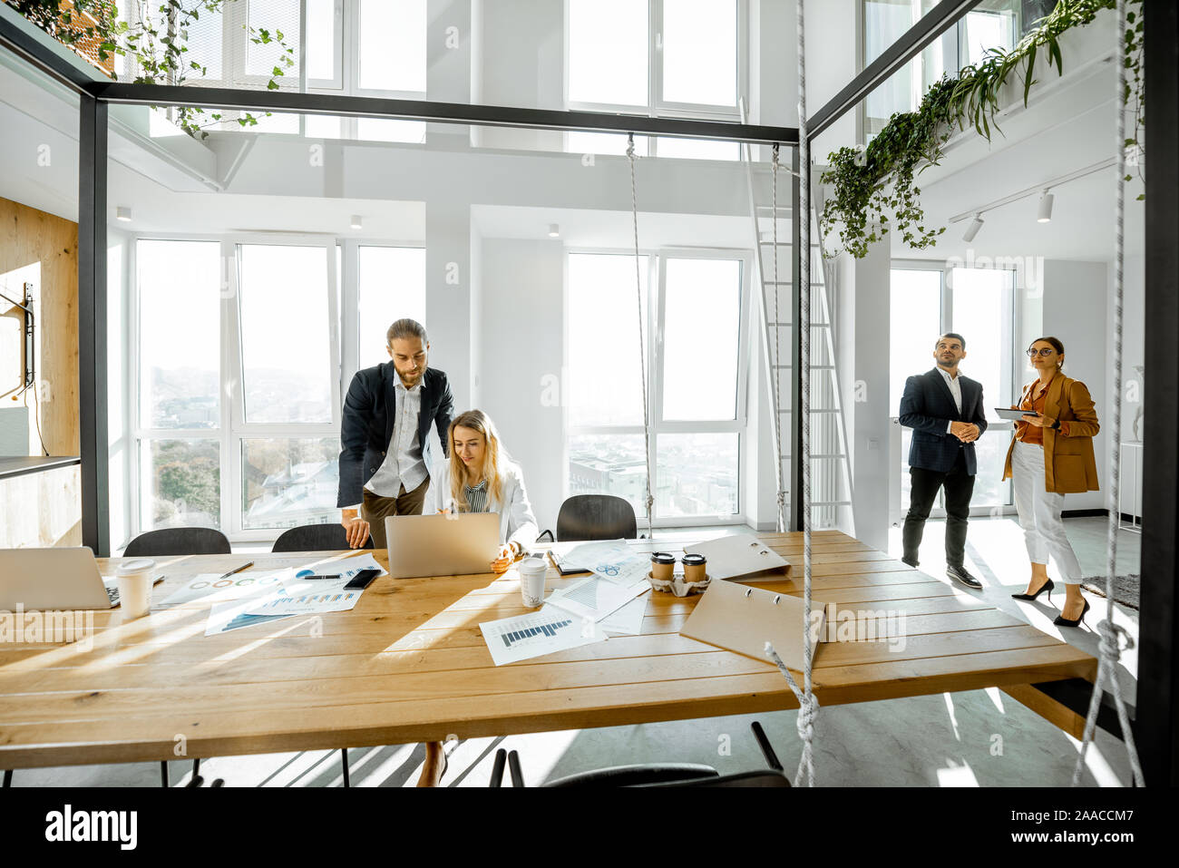 Office employees talking and having some office work at the large ...