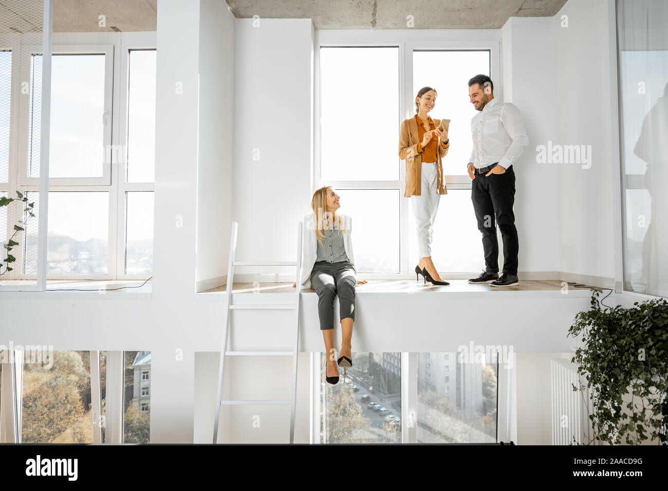 Group of a young creative office employees having some informal ...