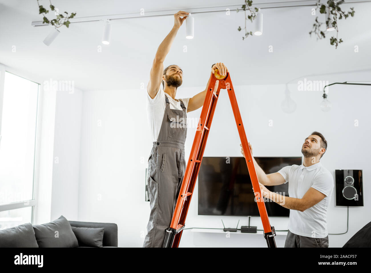 Man ladder light bulb hi-res stock photography and images - Alamy
