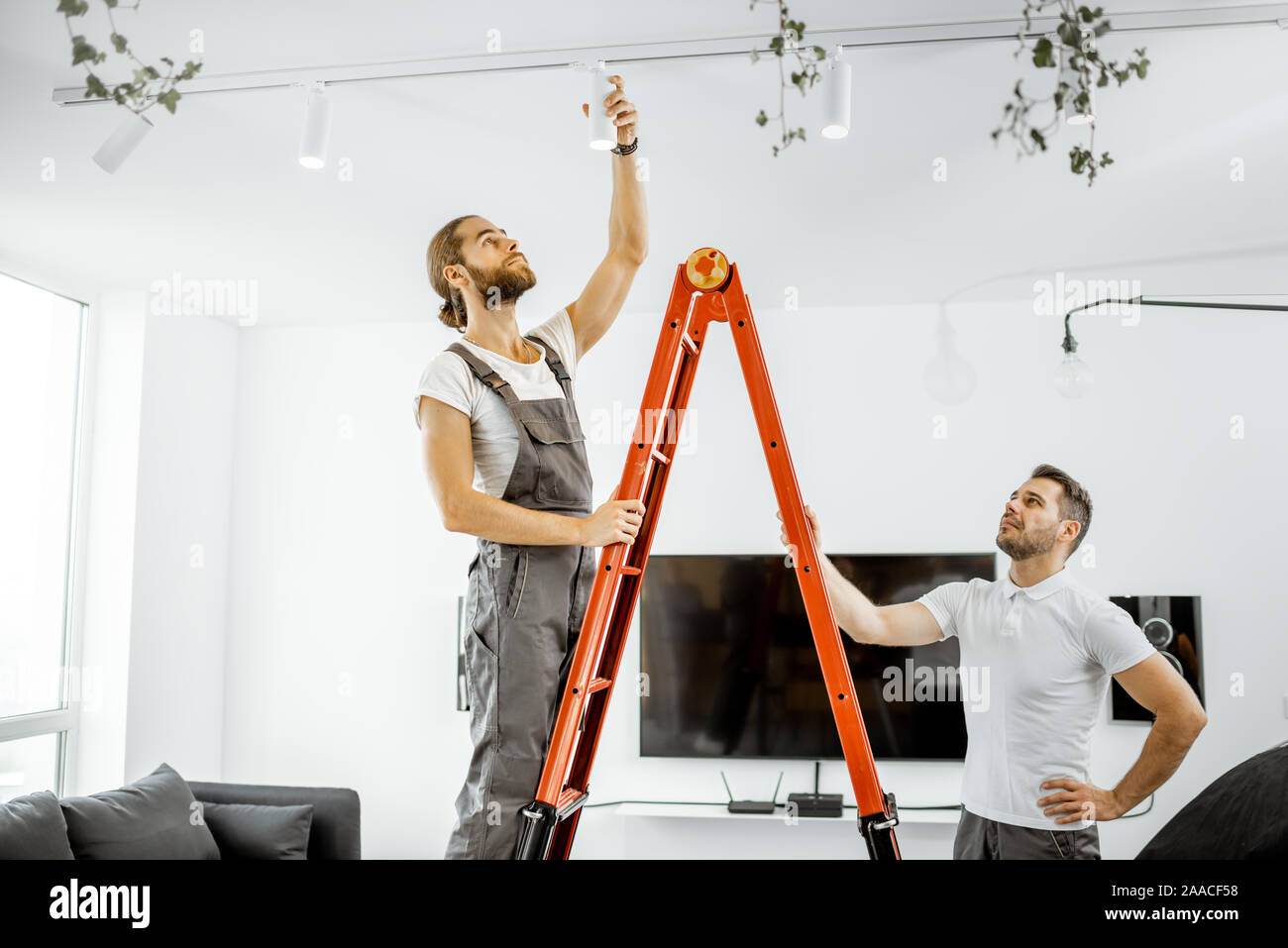 Man ladder light bulb hi-res stock photography and images - Alamy