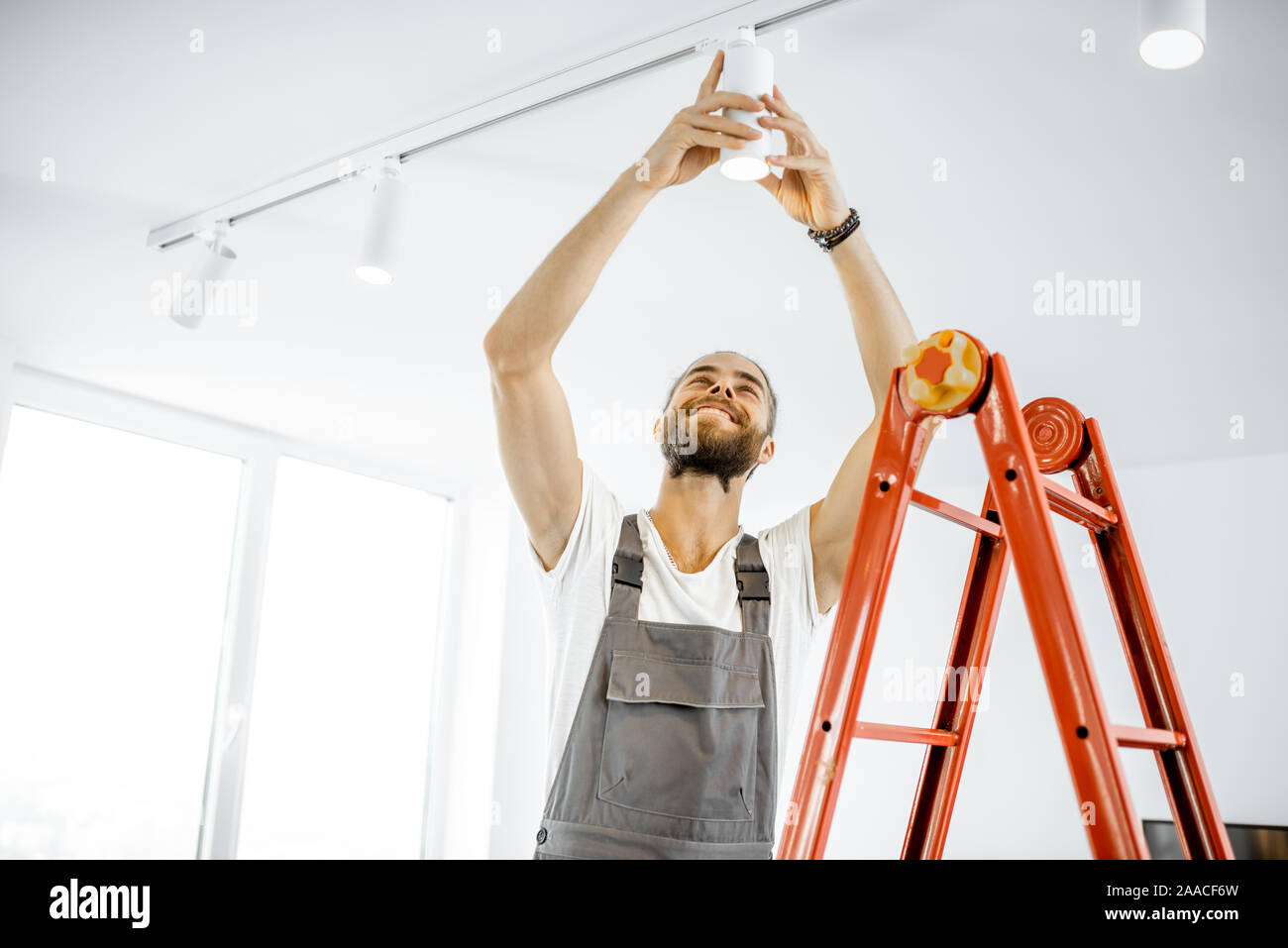 Man ladder light bulb hi-res stock photography and images - Alamy
