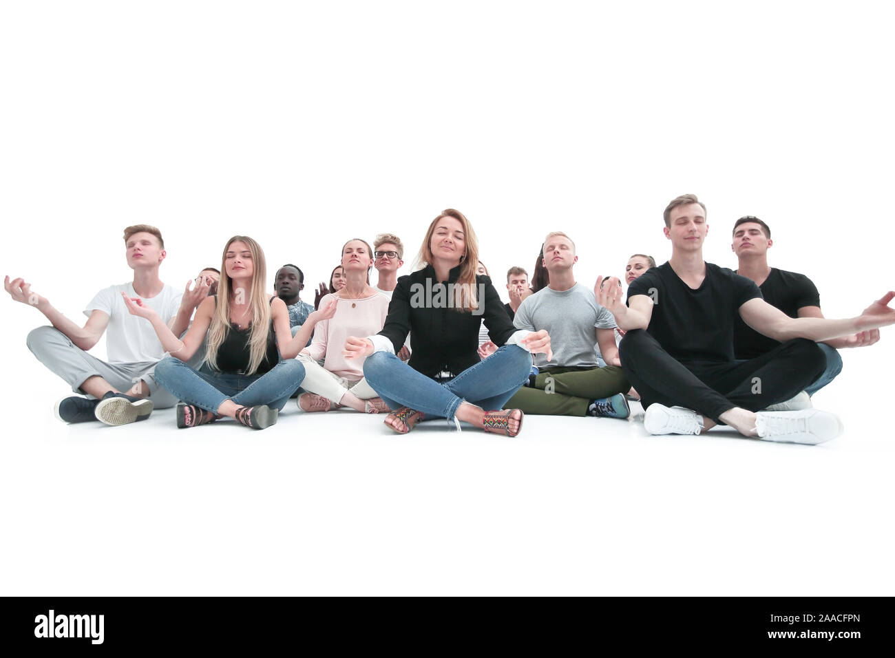 group of young people sitting on the floor in a spacious hall Stock ...