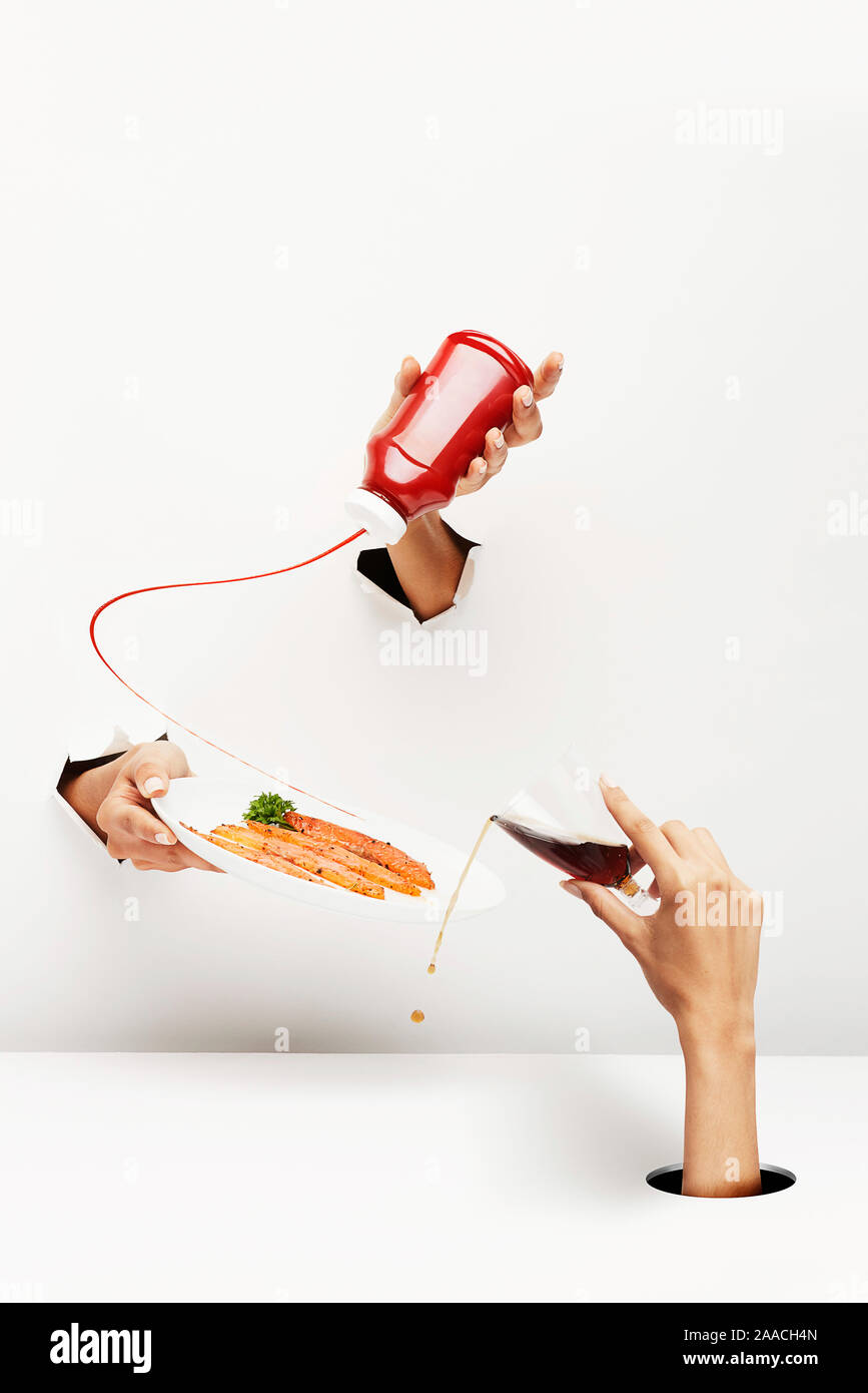 Studio shot of 3 women's hand coming out from the white background and ...