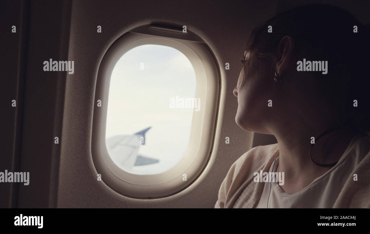 Long flight on aircraft. Portrait of sleepy tired woman is looking at ...