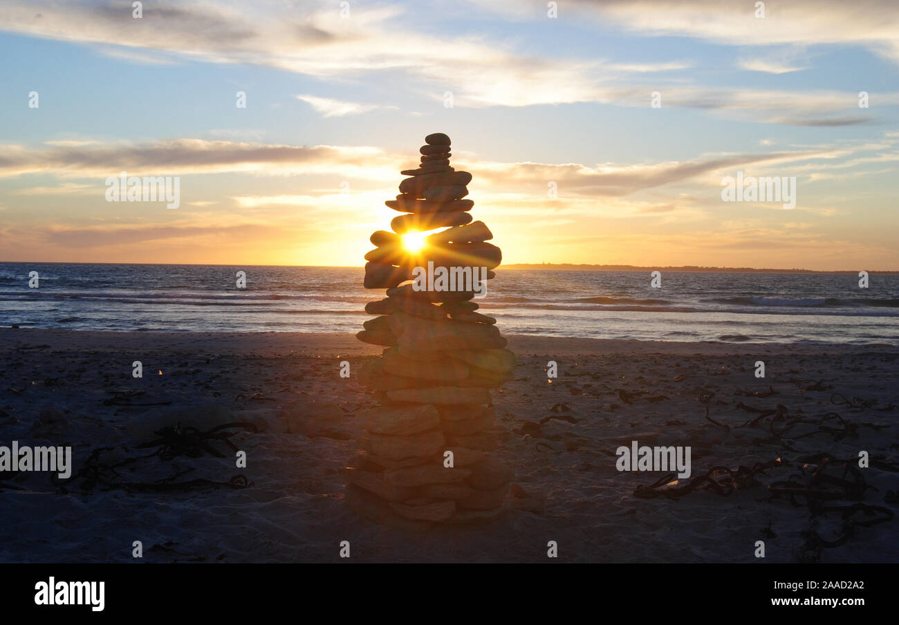 Sunset through stones Stock Photo - Alamy