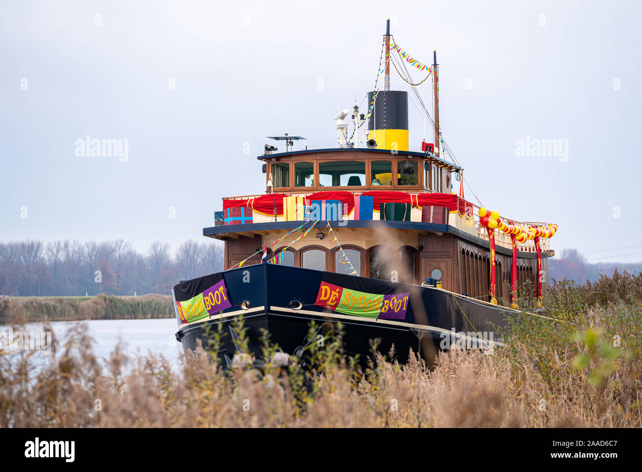 Classic steam ship with wooden paneling on the quay of a harbor with ...